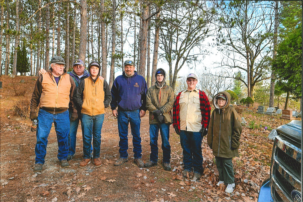 Three generations of community volunteers recover cemetary flags ...